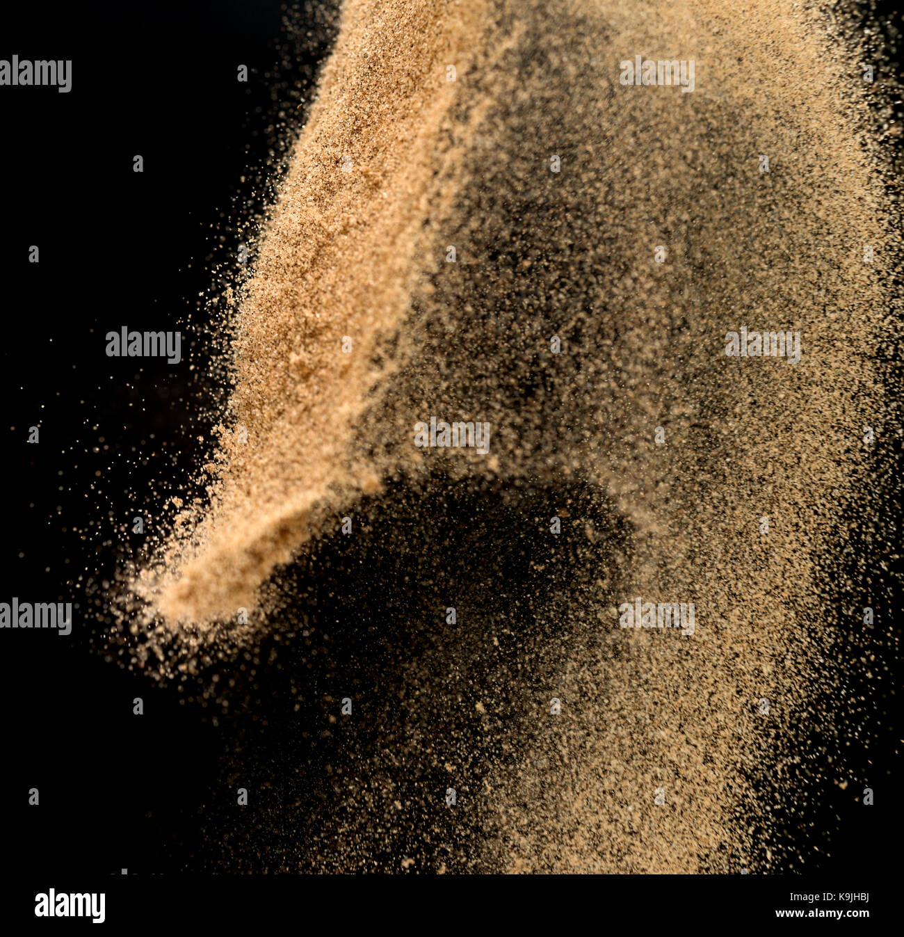 sand explosion on a black background Stock Photo - Alamy