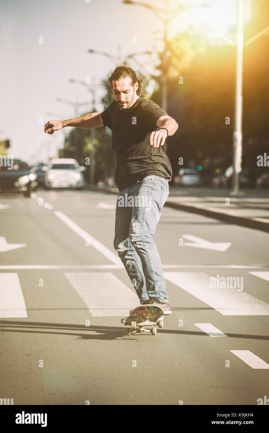 Pro skateboarder ride skateboard on the capital city road streets ...