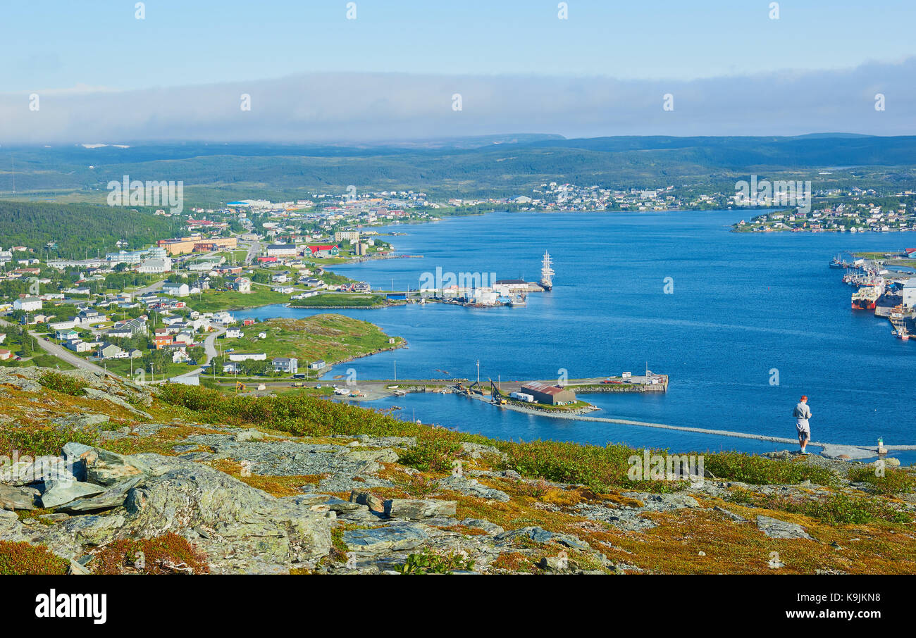 Male tourist looking at panorama of St Anthony and surrounding coast ...
