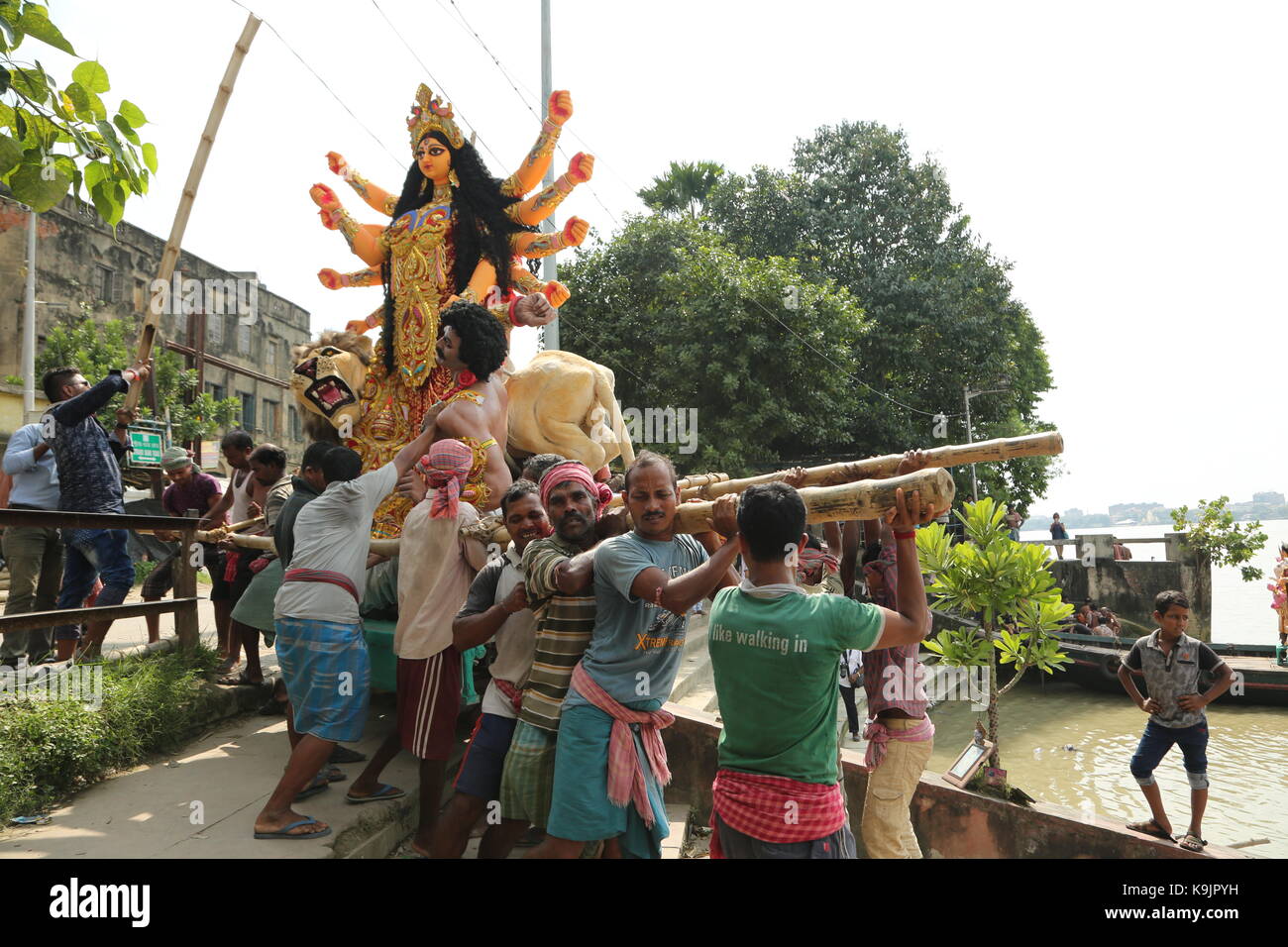A clay statue of the Indian Hindu goddess Durga is transported from a ...