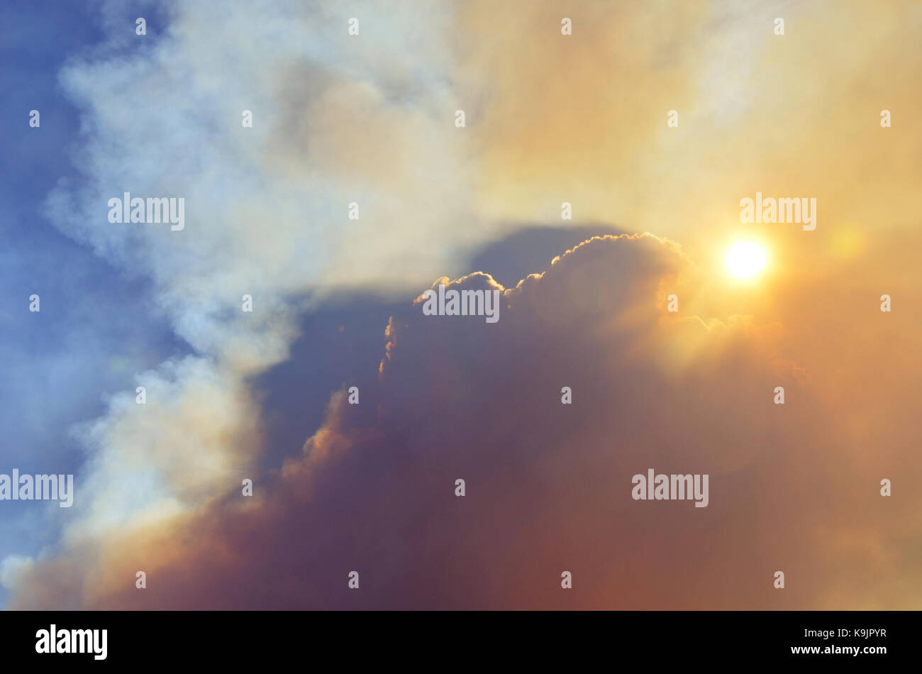 Bushfire smoke rising into the sky and blocking the sun. Natural ...