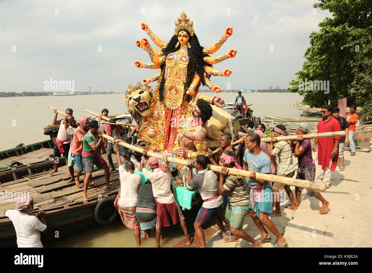 A clay statue of the Indian Hindu goddess Durga is transported from a ...