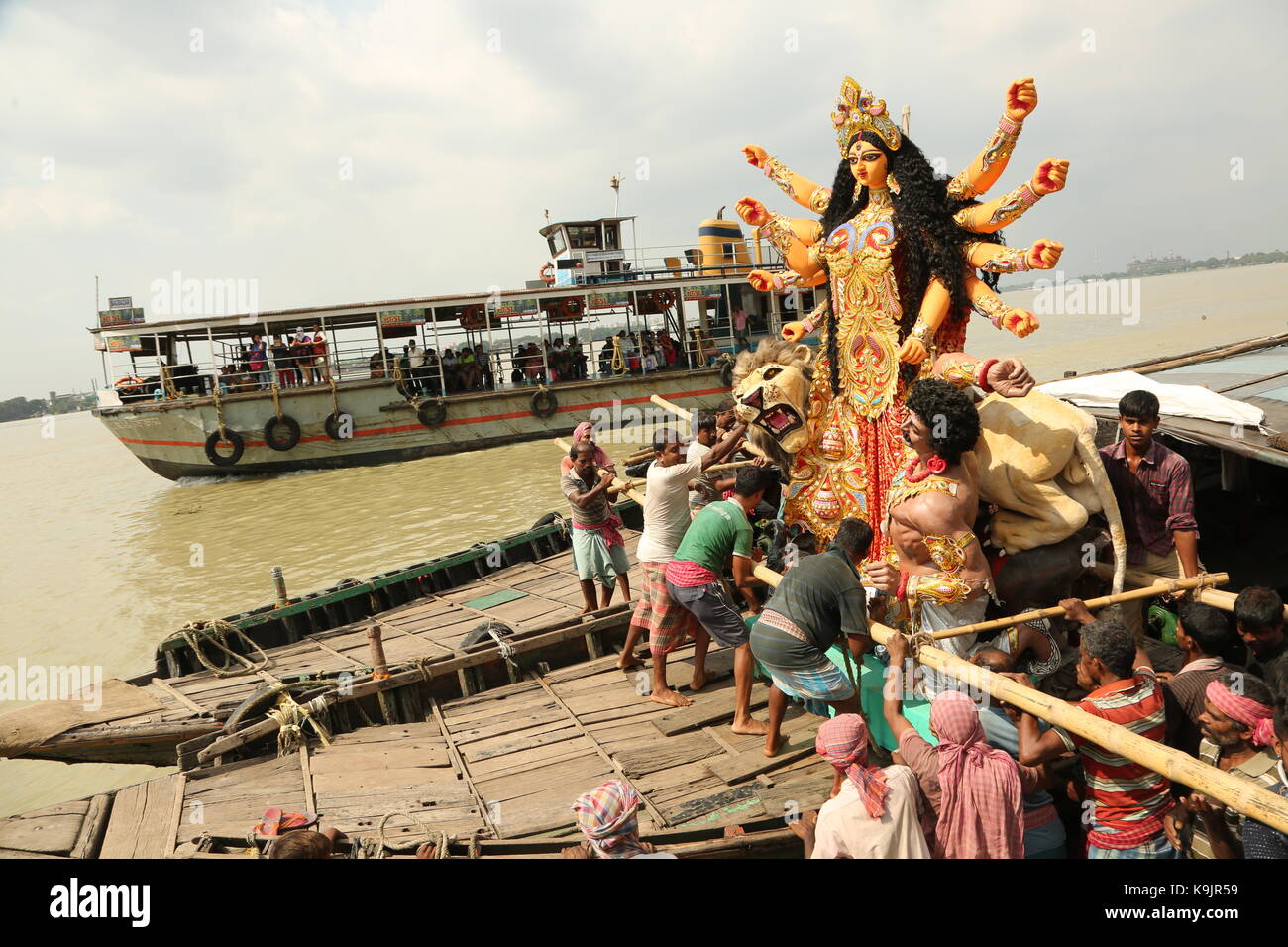A clay statue of the Indian Hindu goddess Durga is transported from a ...