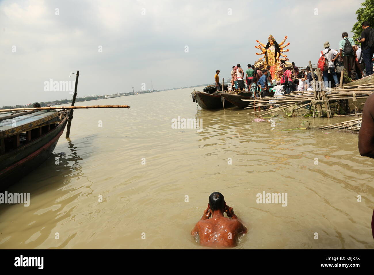 A clay statue of the Indian Hindu goddess Durga is transported from a ...