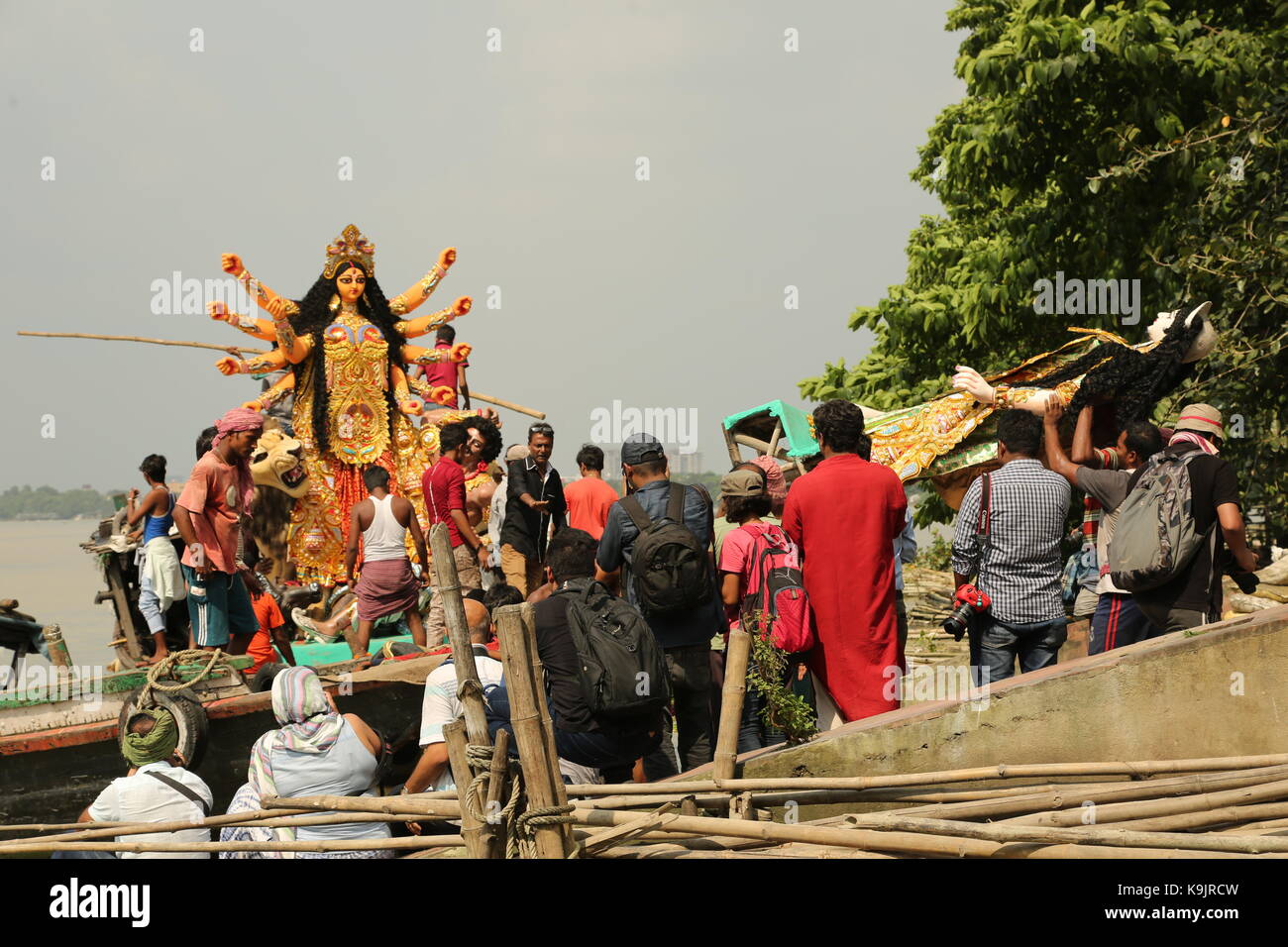 A clay statue of the Indian Hindu goddess Durga is transported from a ...