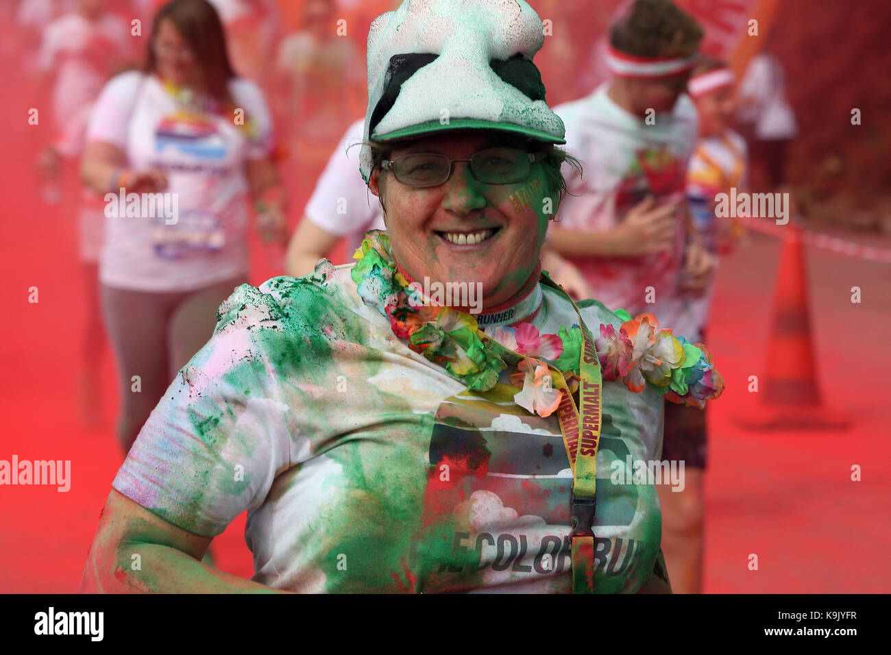 A colourful runner at the Brighton 5K Color Run, Madeira Drive ...