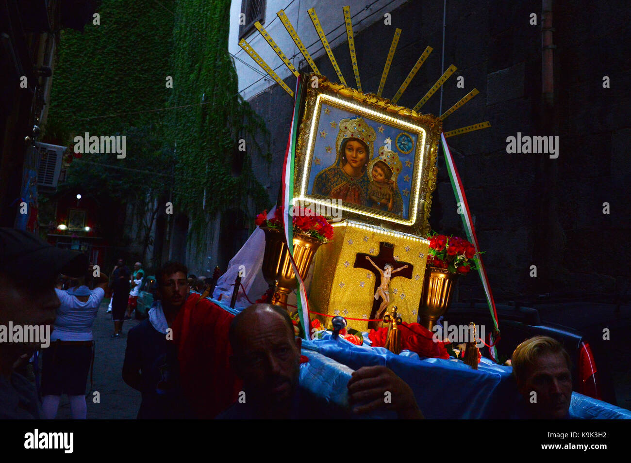 A procession bearing inages of Mary, the mother of Jesus, makes its way ...