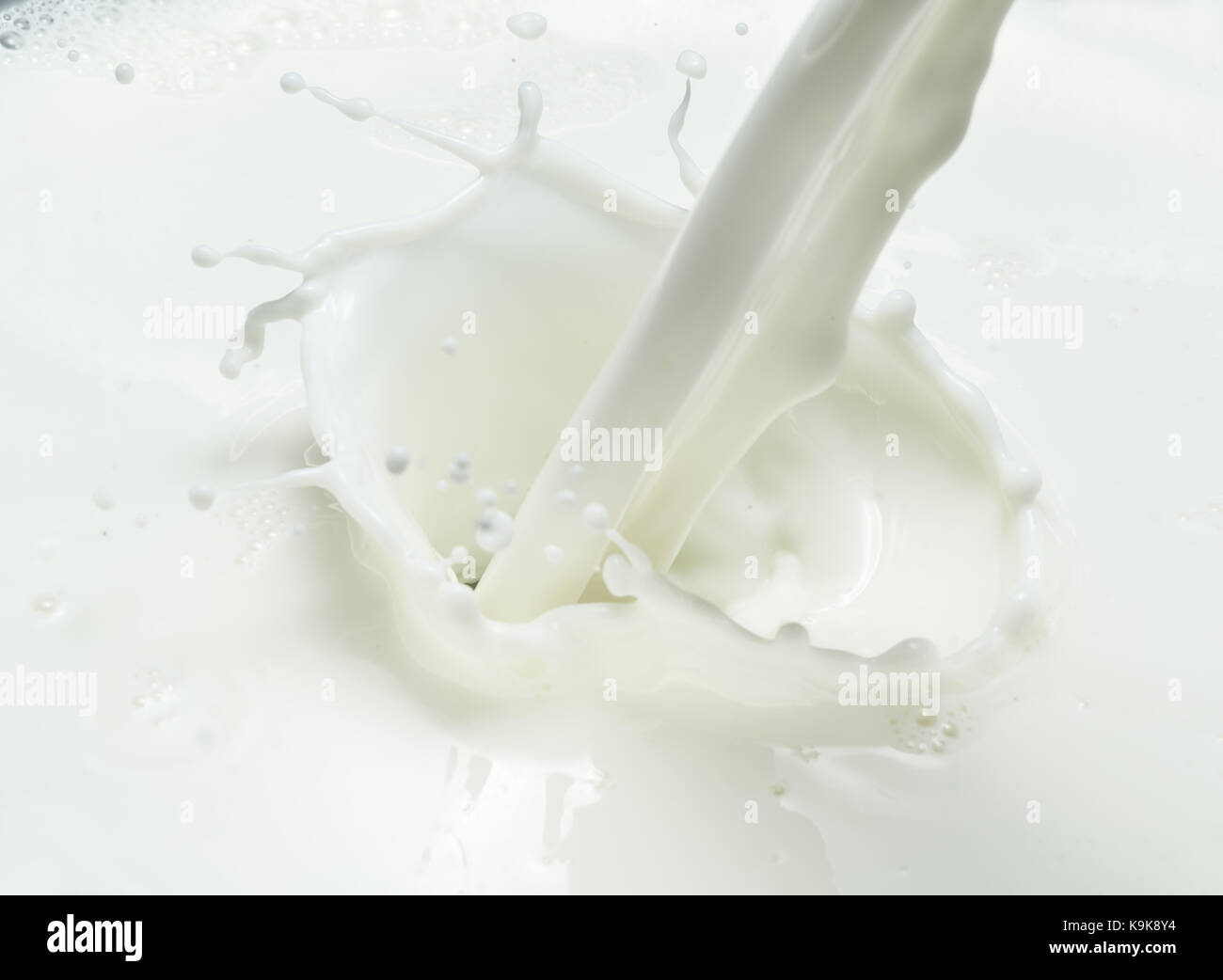 Pouring milk and milk splash. Close-up Stock Photo - Alamy