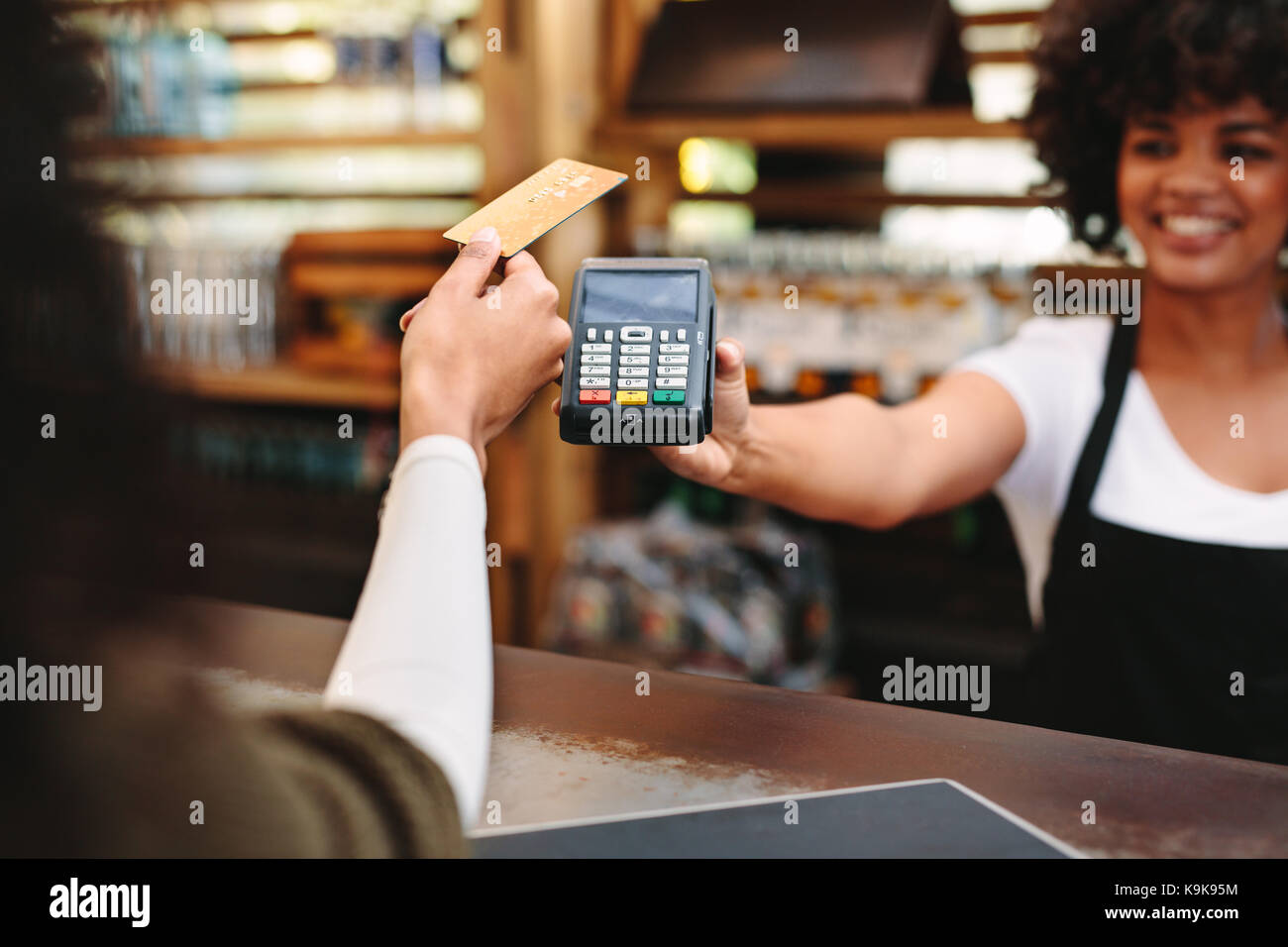 Customer making wireless or contactless payment using credit card ...
