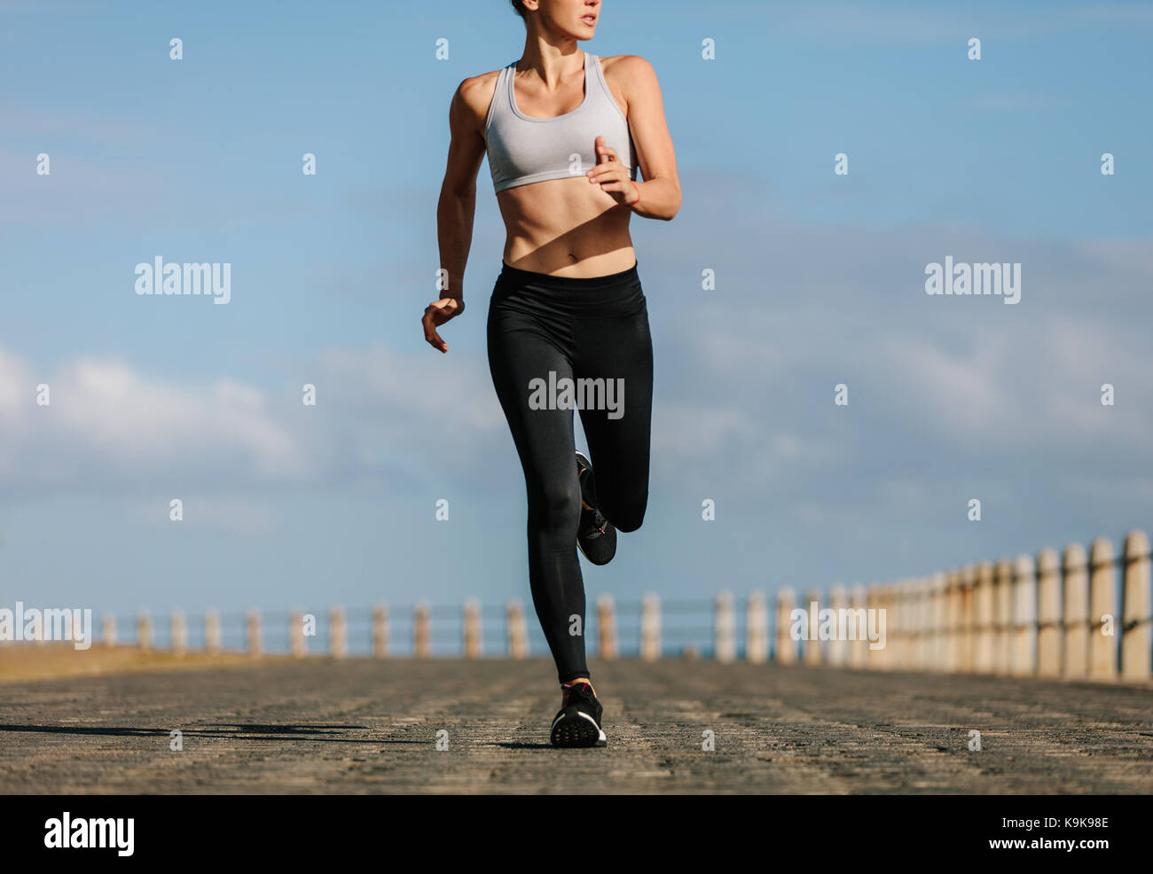 Female runner working out in the morning. Young woman running on the ...