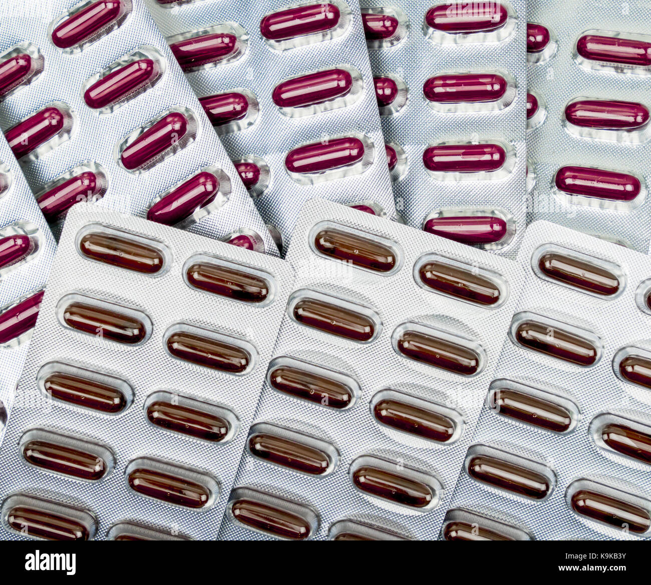 Heap of red capsules pills in blister pack. Vitamins and supplements ...