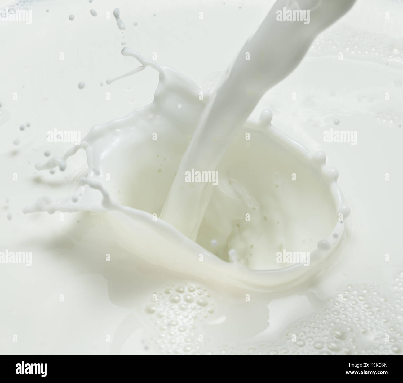 Pouring milk and milk splash. Close-up Stock Photo - Alamy