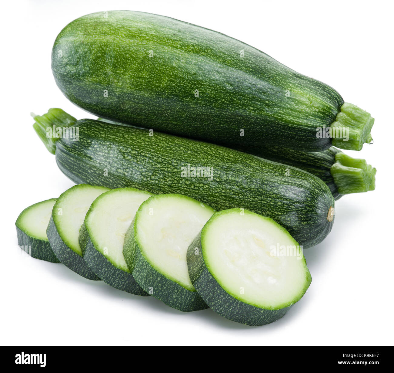 Zucchini with slices on a white background Stock Photo - Alamy
