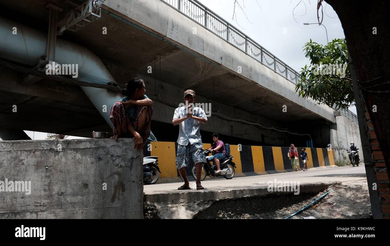 Phnom Penh Cambodia Monivong Bridge Bassac River Slum Area men hanging ...