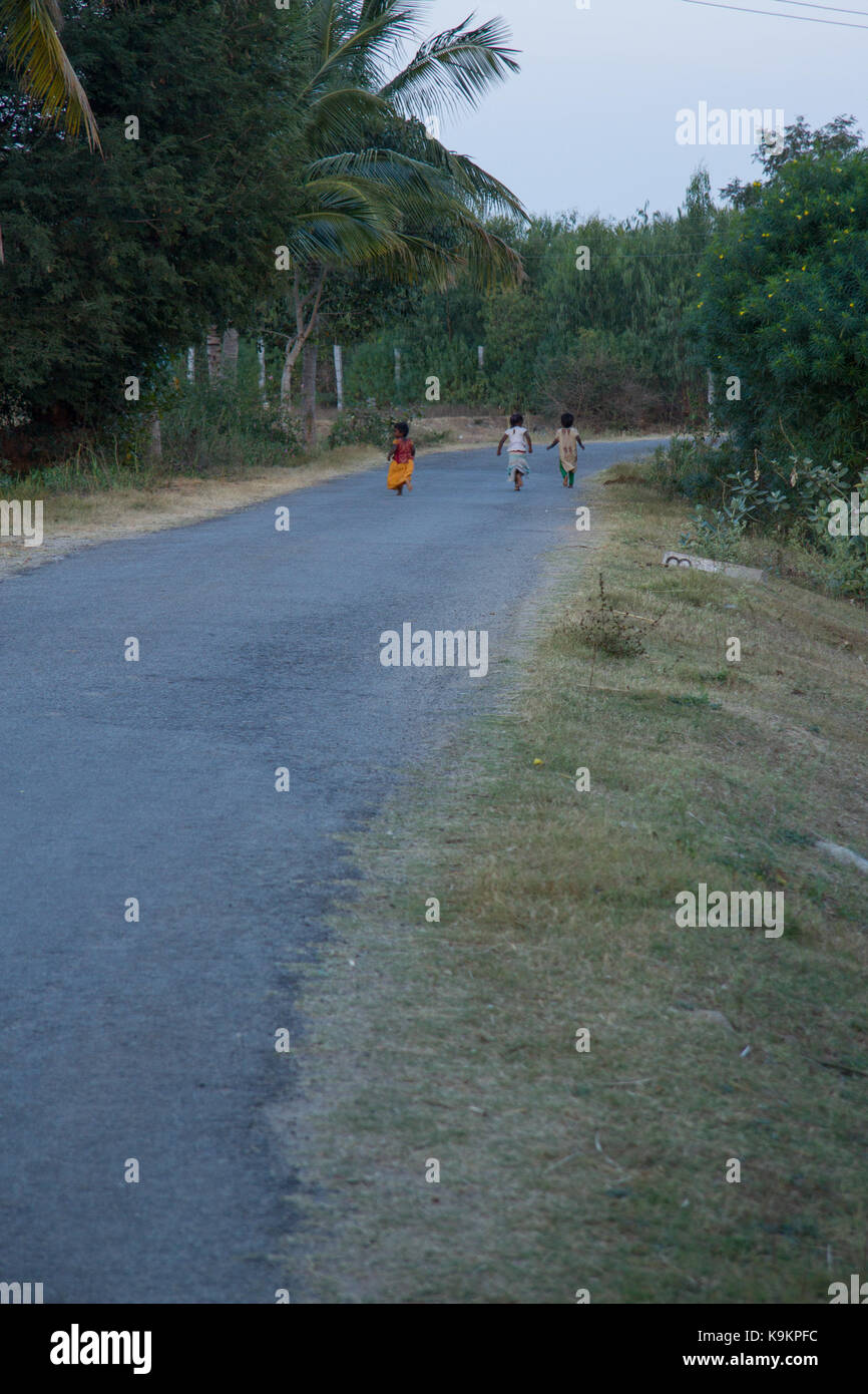 Children running down a road in Southern India Stock Photo - Alamy