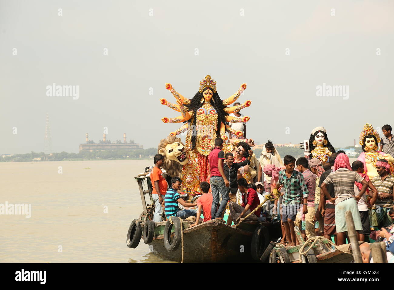 A clay statue of the Indian Hindu goddess Durga is transported from a ...
