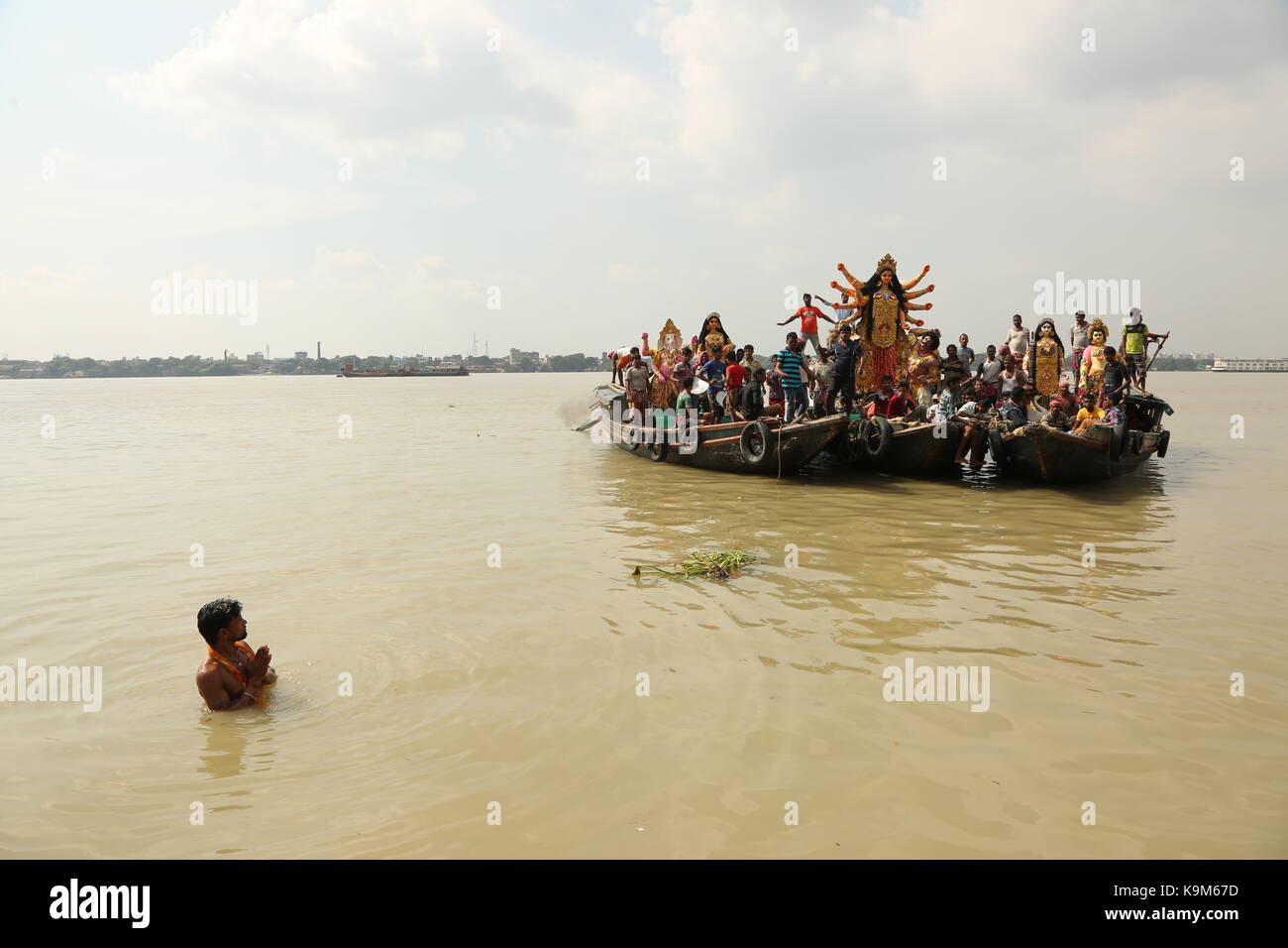 A clay statue of the Indian Hindu goddess Durga is transported from a ...