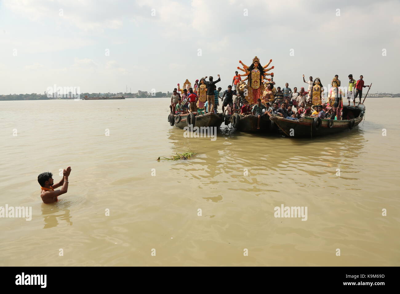 A clay statue of the Indian Hindu goddess Durga is transported from a ...