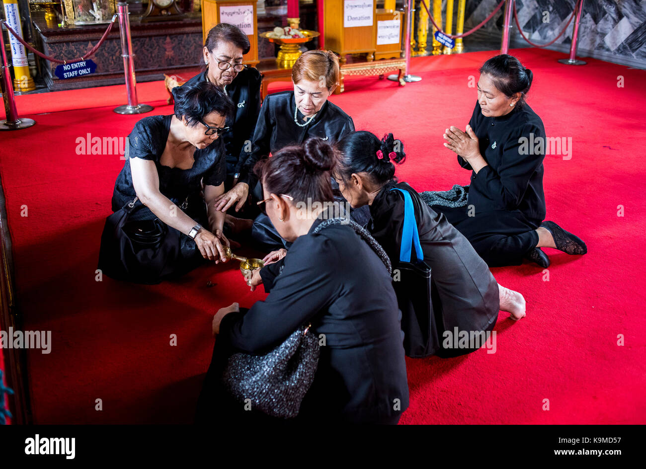 Women doing a religious ritual, in Wat Arun (Temple of Dawn), also ...
