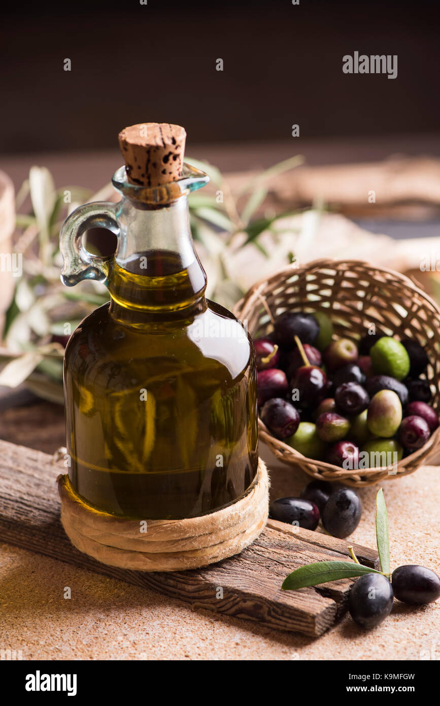 Olive oil and olives on wooden rustic table Stock Photo - Alamy