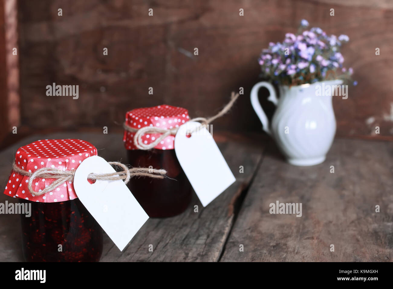 rustic homemade jam jar wooden background and flower Stock Photo - Alamy