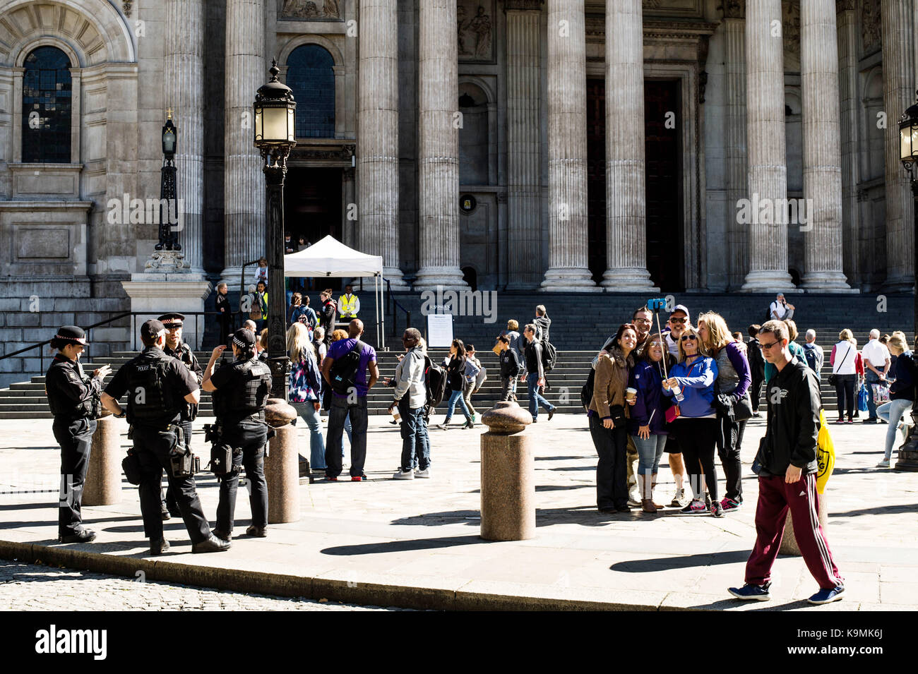 Armed Police Talking and Tourists Taking a Group Selfie Side by Side ...