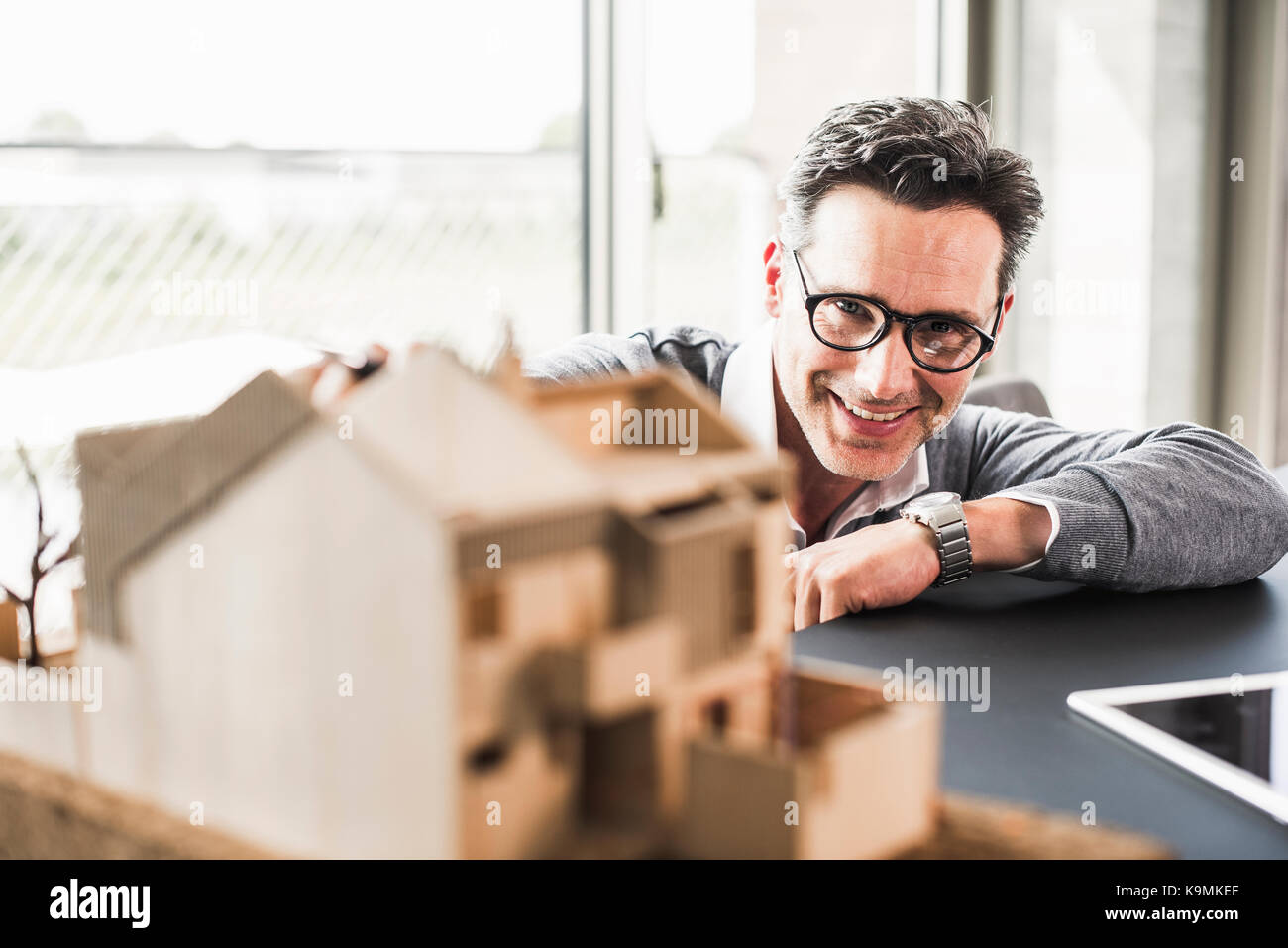Portrait of smiling architect working on architectural model Stock ...