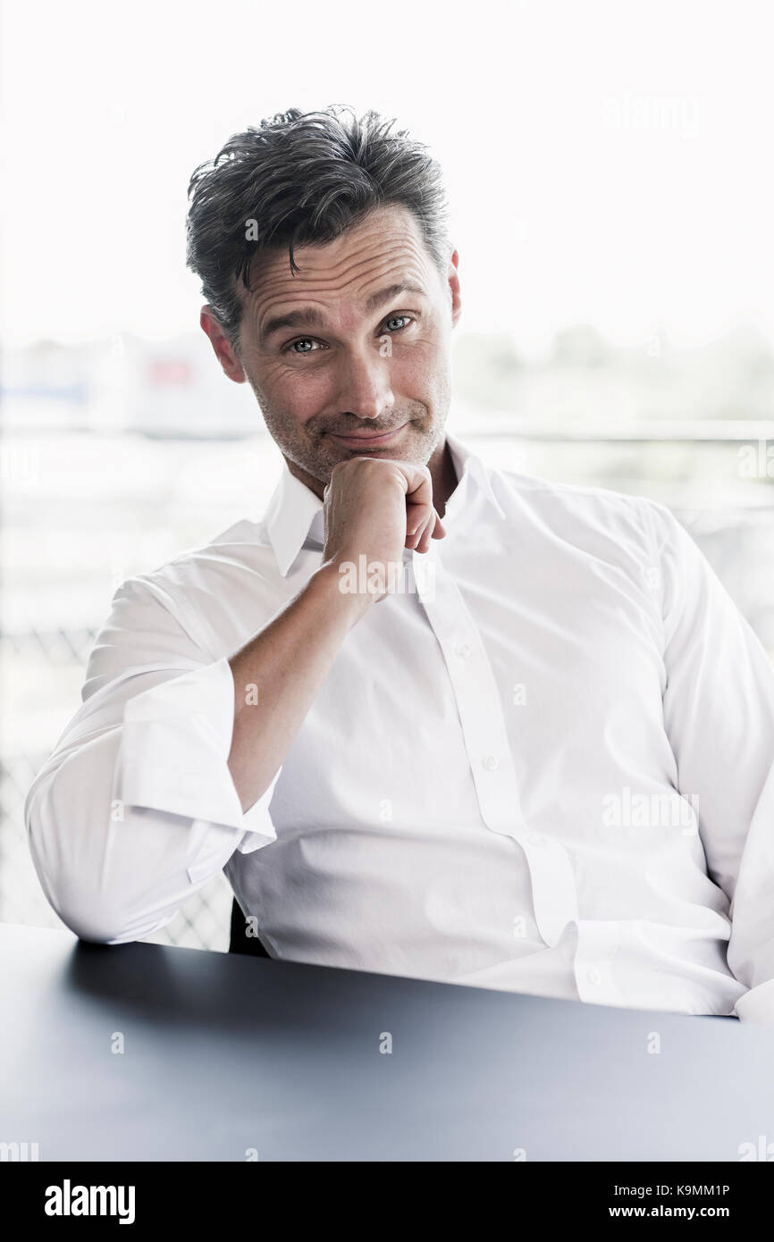Portrait of businessman raising eyebrows Stock Photo - Alamy
