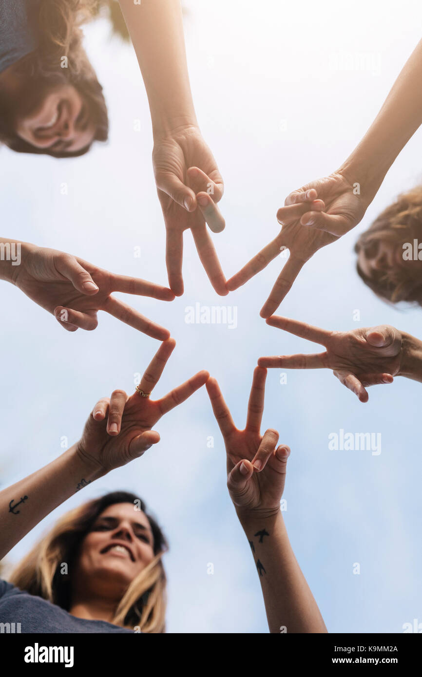 Three women shaping a star with their hands Stock Photo - Alamy