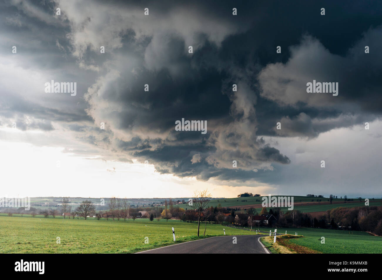 Stormy atmosphere over empty country road Stock Photo - Alamy