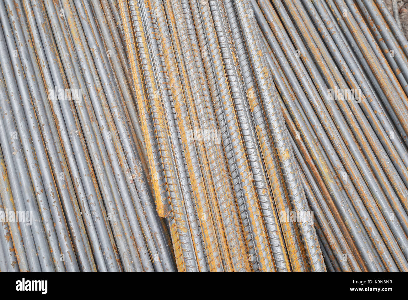 Stack of rusty round steel bar - iron metal rail lines material for ...