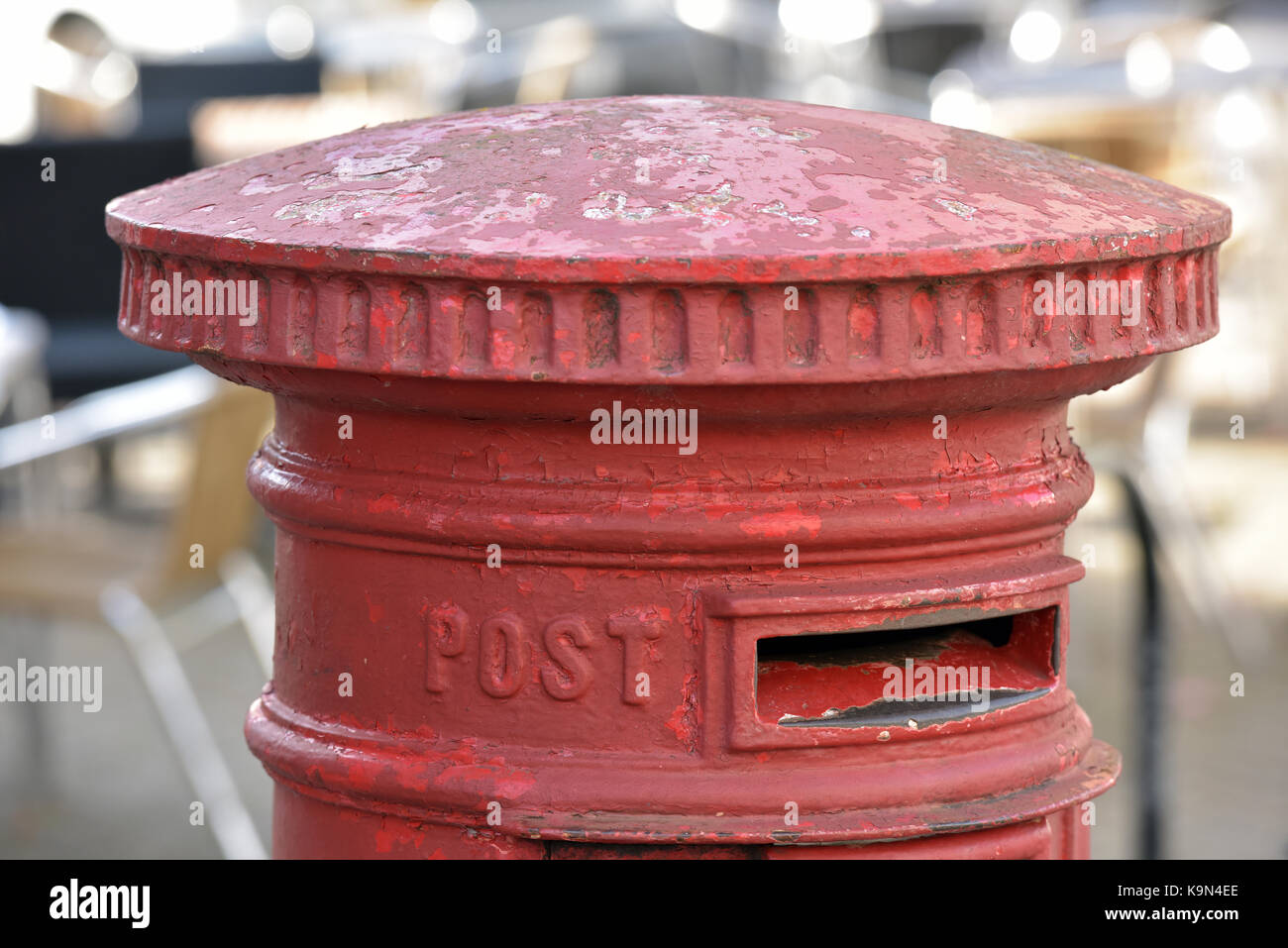 The top of a traditional red letterbox or posting box painted red in ...