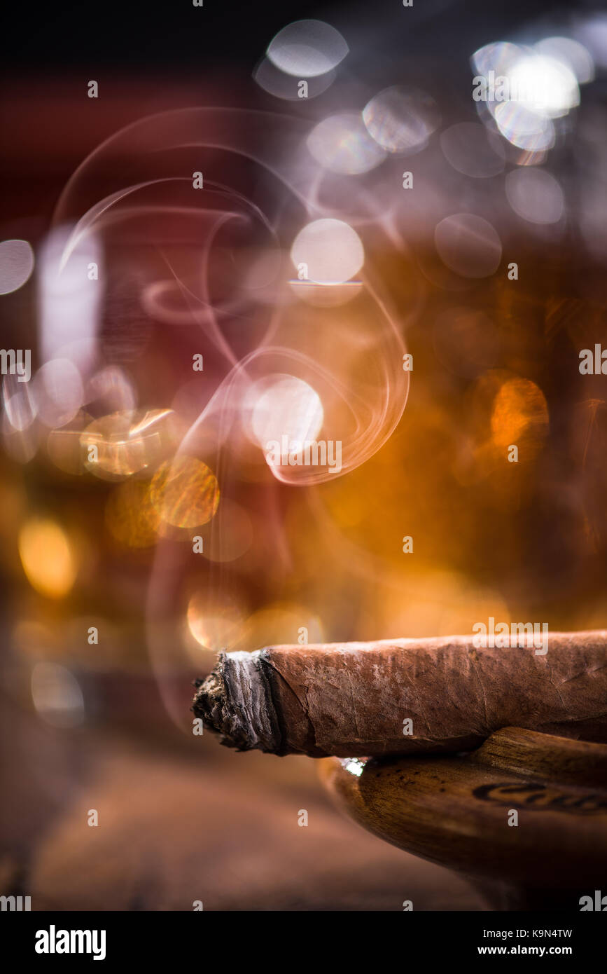 Cuban cigar smoke and luxurious Cognac in carafe Stock Photo - Alamy