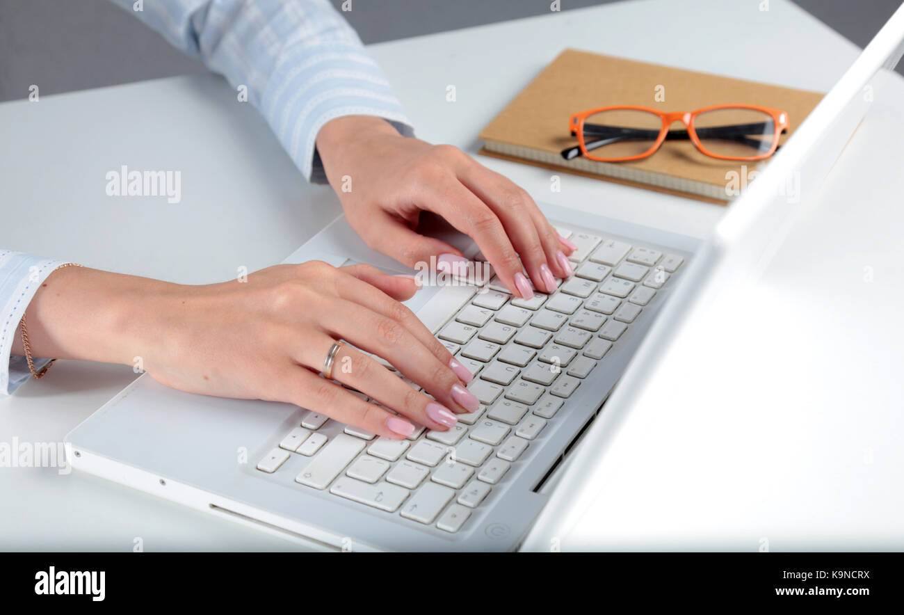 Young pretty business woman with notebook in the office Stock Photo - Alamy