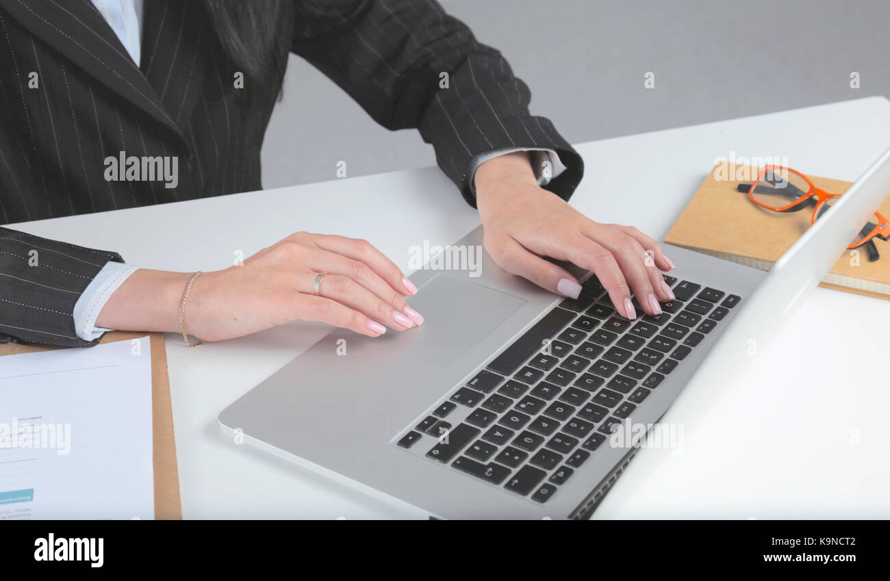 Young pretty business woman with notebook in the office Stock Photo - Alamy