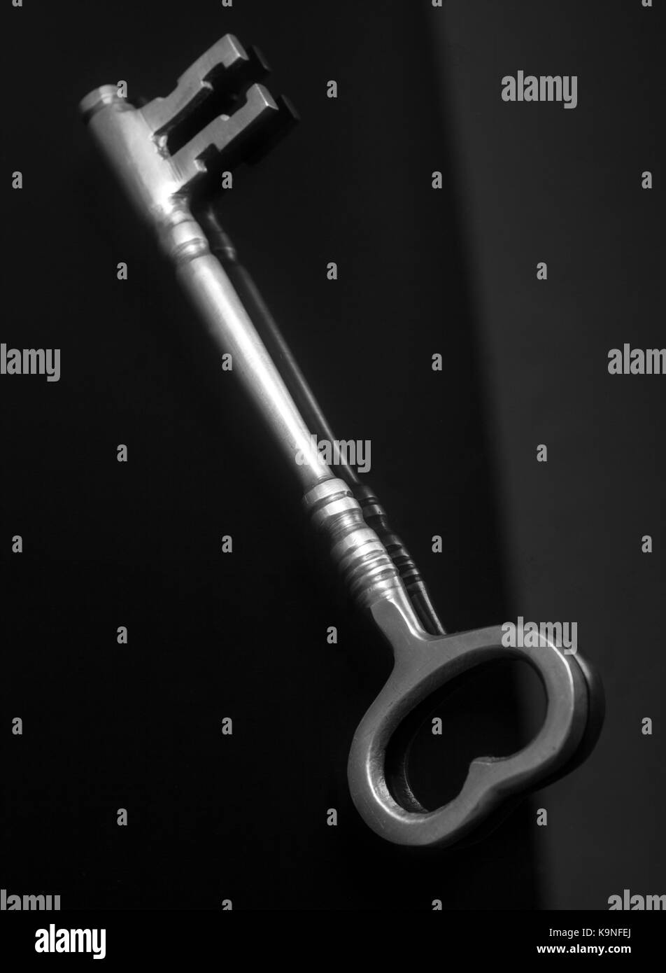 Vintage Key on black background Stock Photo - Alamy