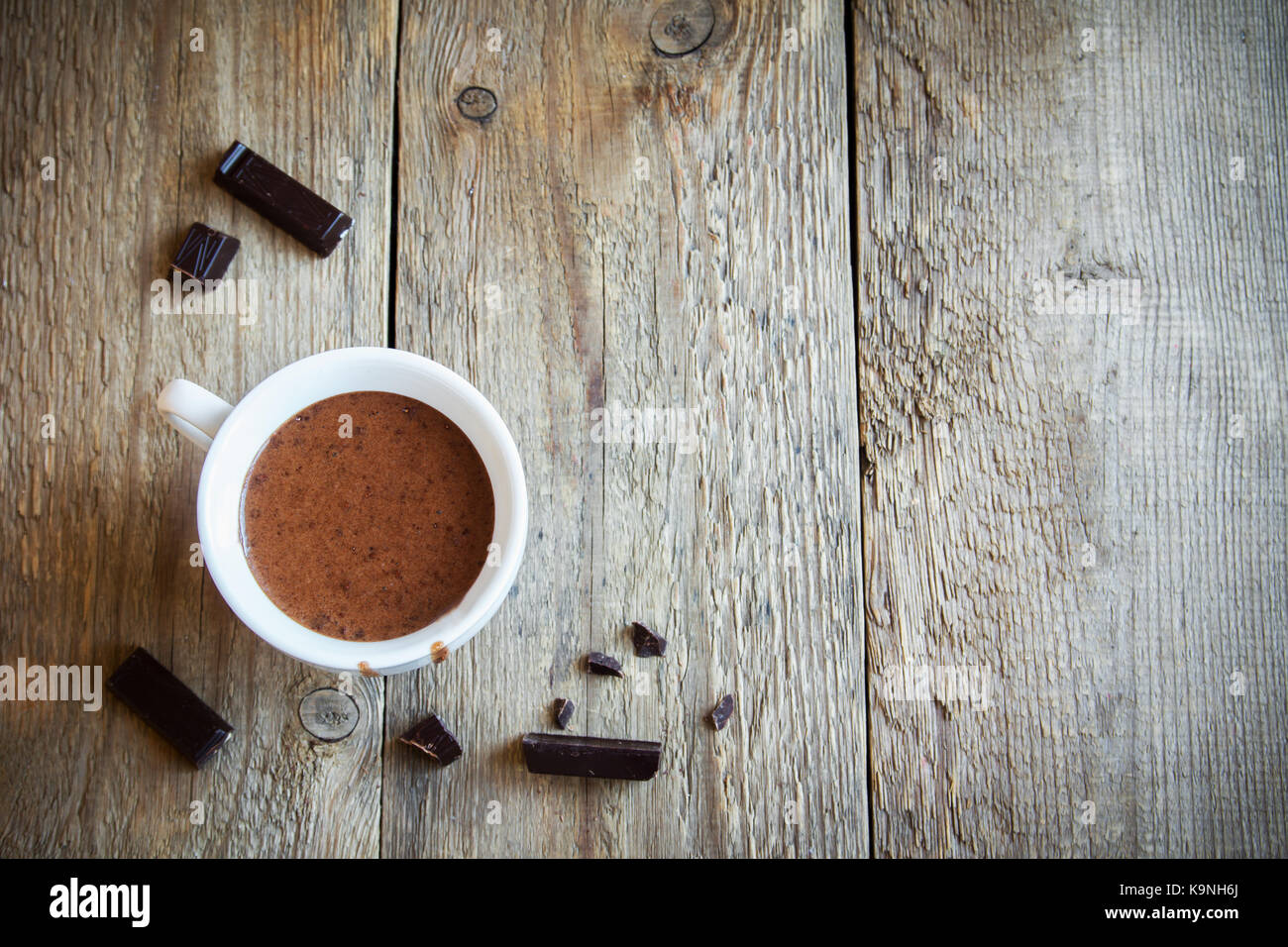 Hot Chocolate and chocolate pieces over rustic wooden background ...