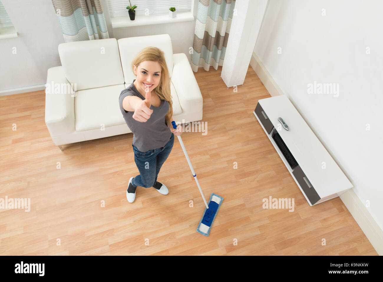Young person mopping floor hi-res stock photography and images - Alamy