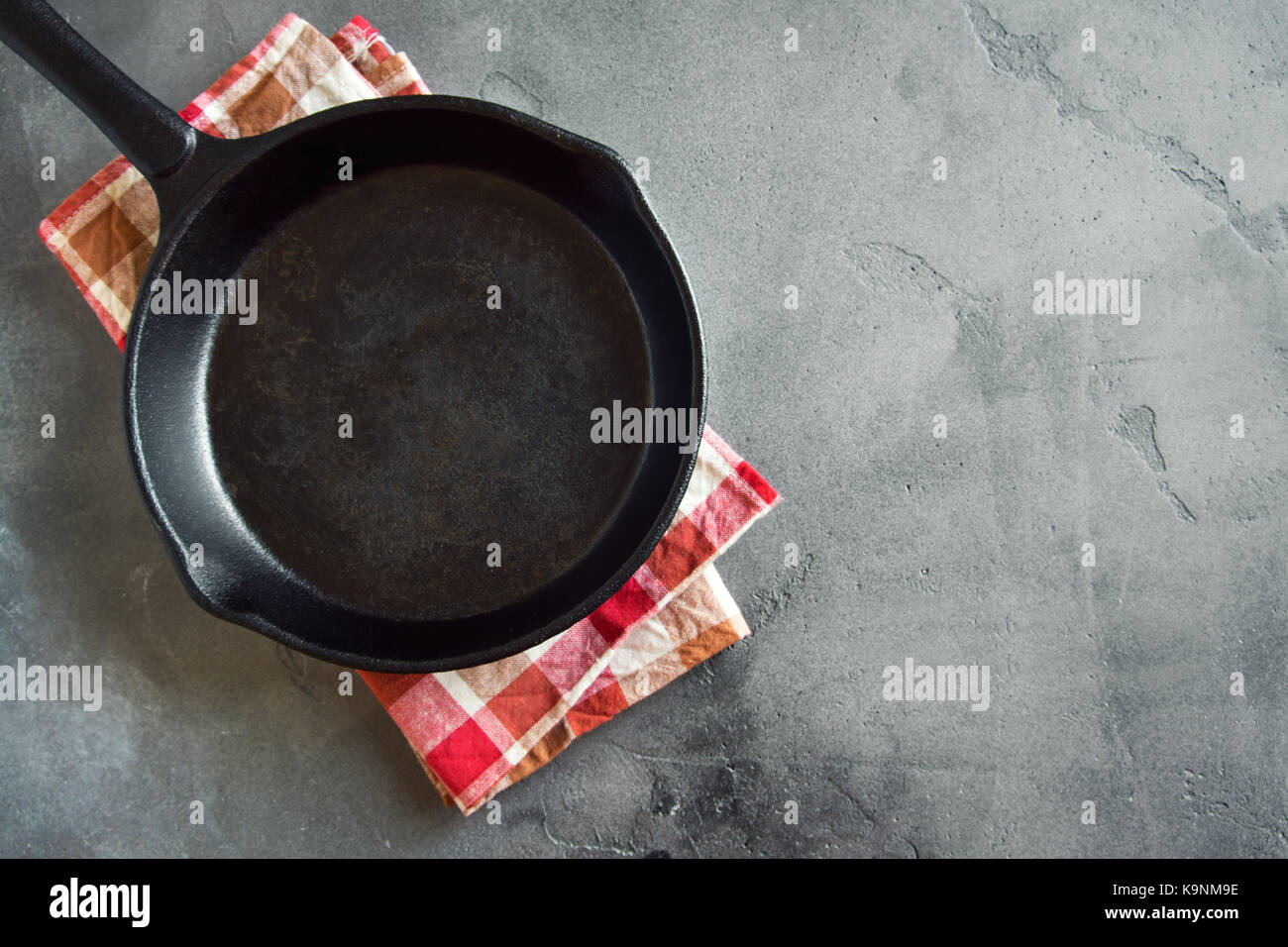 Cast iron pan on rustic grey concrete background close up - empty black ...