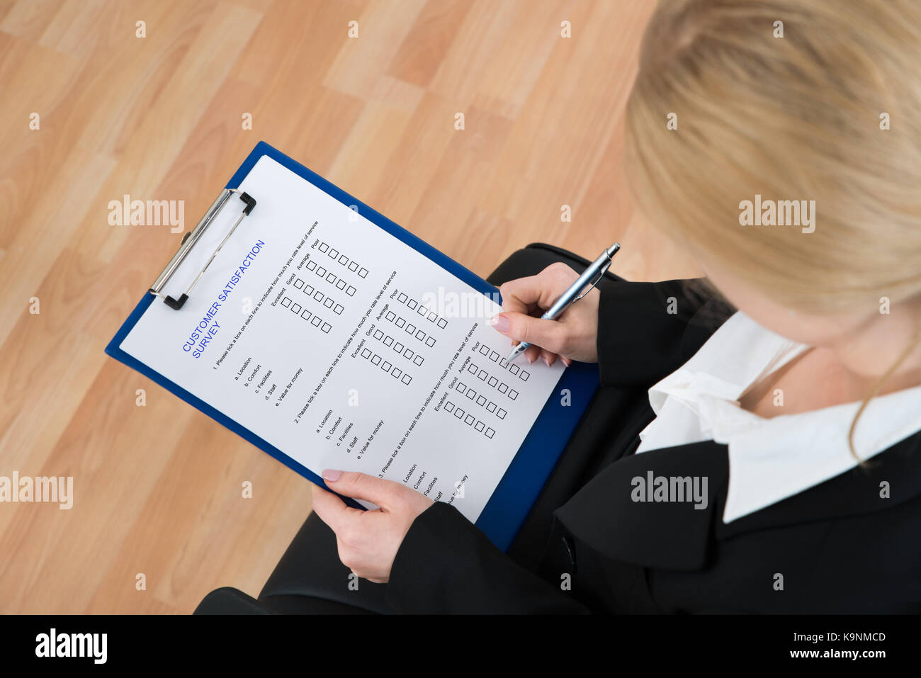 Close-up Of Businesswoman Filling Customer Survey Form On Clipboard ...