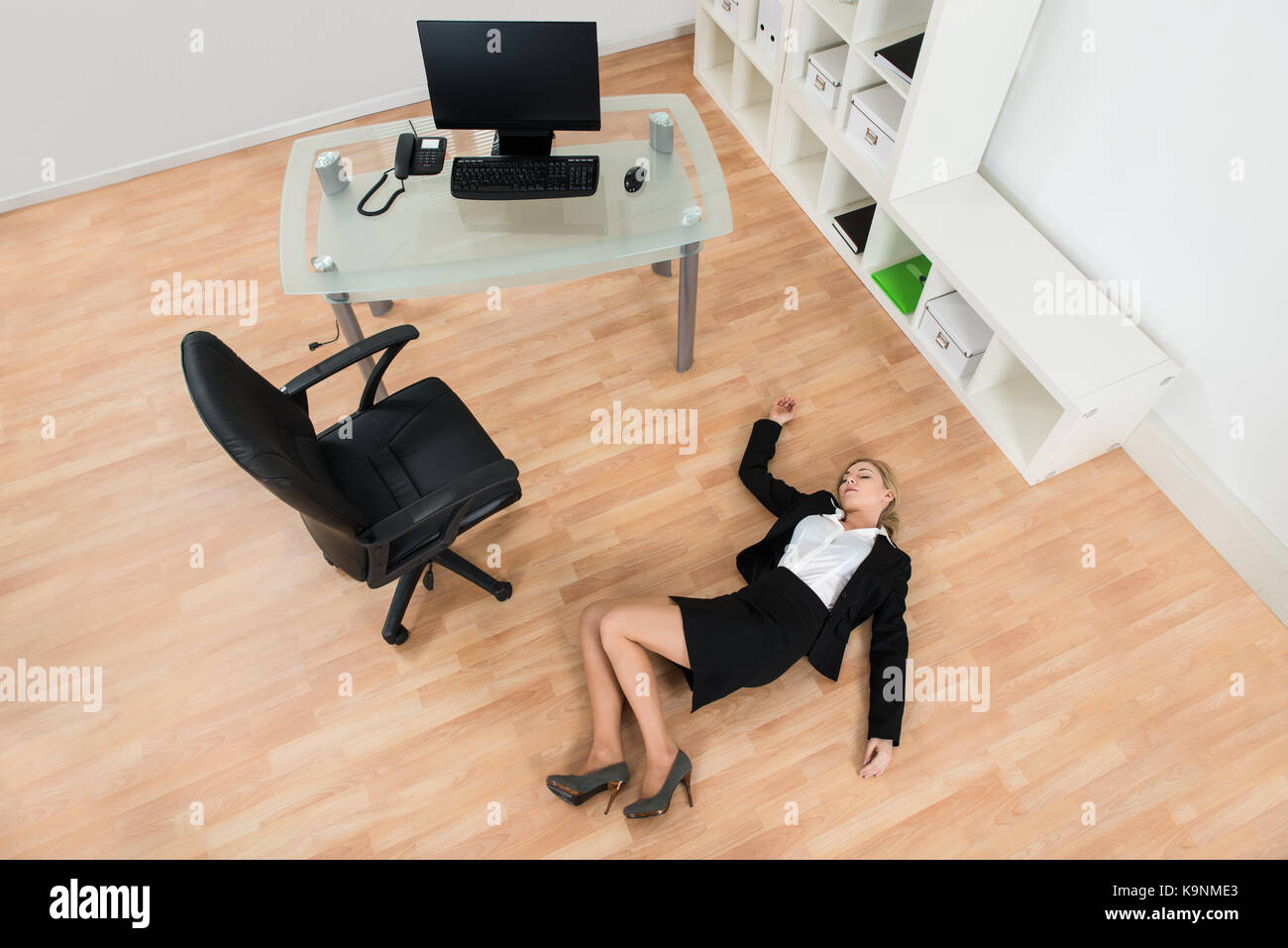 High Angle View Of Young Businesswoman Fainted On Floor In Office Stock ...