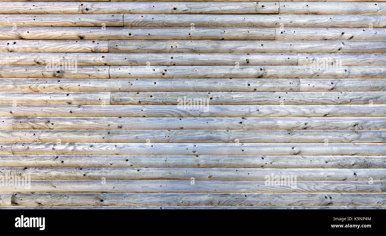 The gray logs of the wooden wall are folded horizontally. Texture of an ...