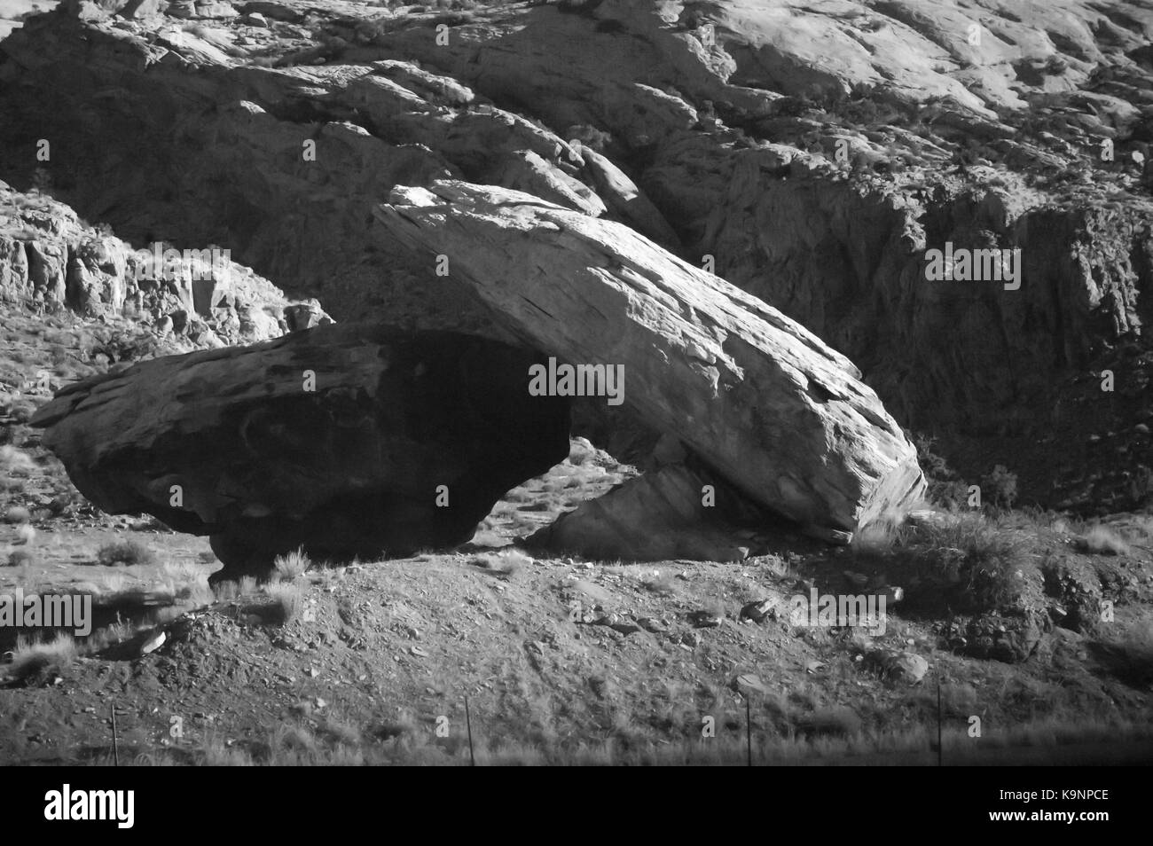 Two large rocks leaning up against each other in black and white Stock ...