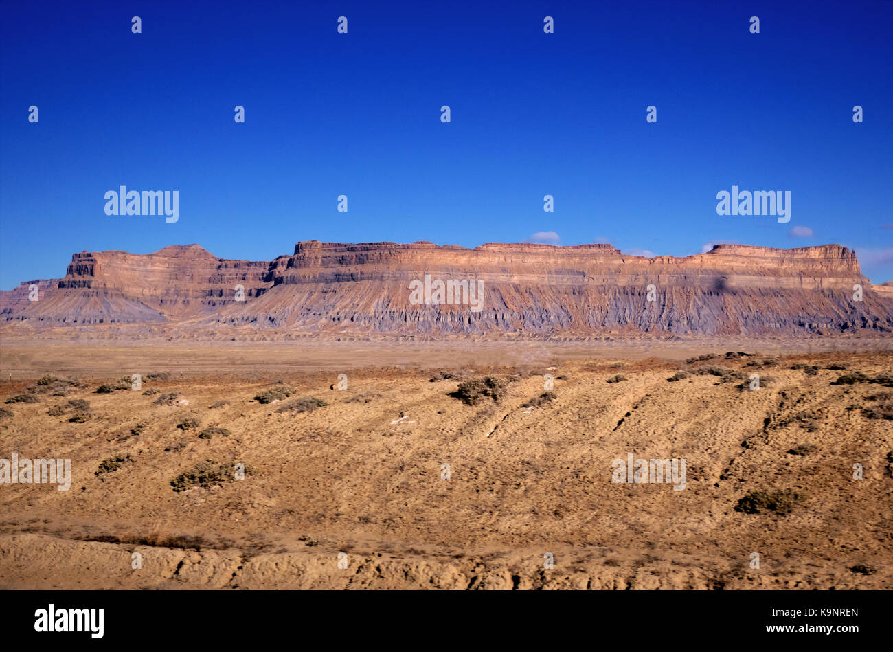 A rock plateau standing up on a blue sky with a red hint Stock Photo ...