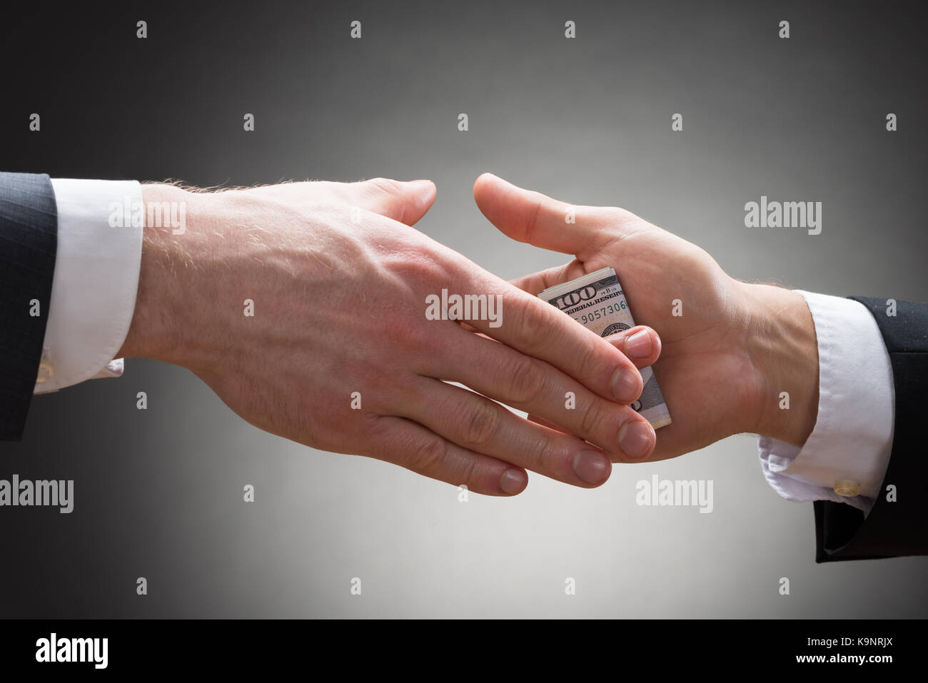 Close-up Of Businessman Hand Giving Bribe To Other Businessperson Stock ...