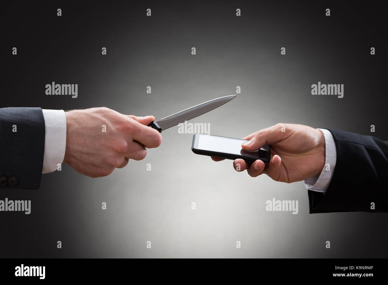 Close-up Of Businessman Hand Showing Knife To The Businessperson With ...