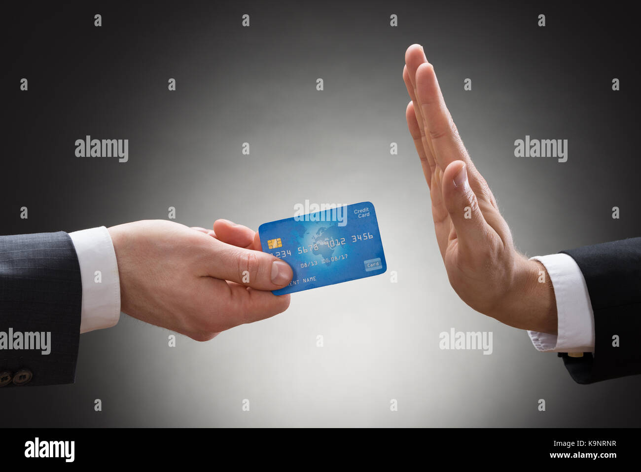 Close-up Of A Businessman's Hand Avoiding Credit Card Stock Photo - Alamy