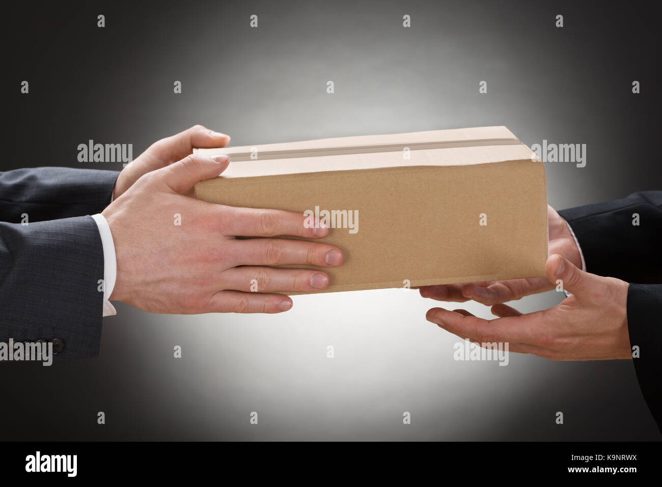 Close-up Of A Businessman Giving Box To His Colleague Stock Photo - Alamy