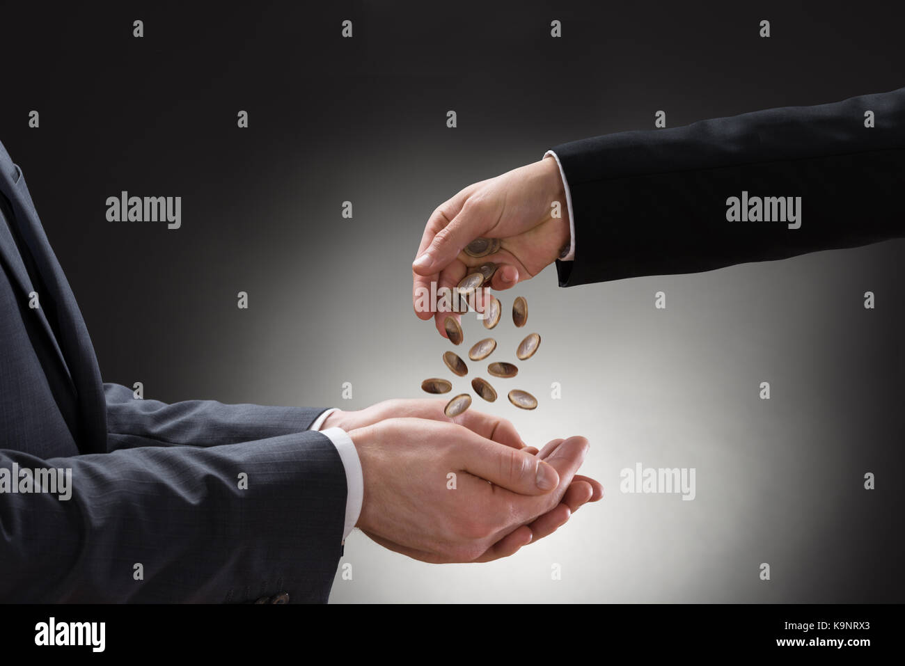 Close-up Of A Businessman Hand Pouring Coins On Colleague's Hand Stock ...