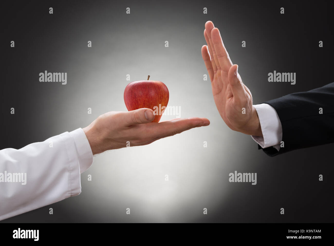 Close-up Of A Person's Hand Refusing Red Apple Held By Doctor Stock ...